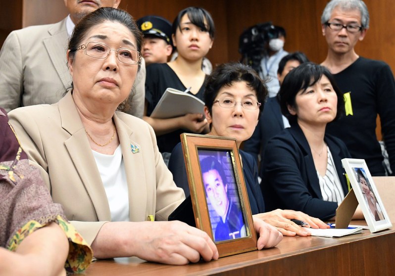 Families of overwork death victims decry adoption of new labor bill ...