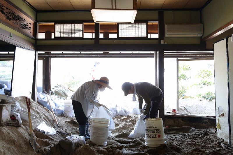 In Photos: Search for missing, cleanup work continues in disaster hit ...
