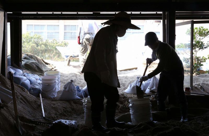 In Photos: Search for missing, cleanup work continues in disaster hit ...