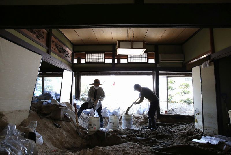 In Photos: Search for missing, cleanup work continues in disaster hit ...