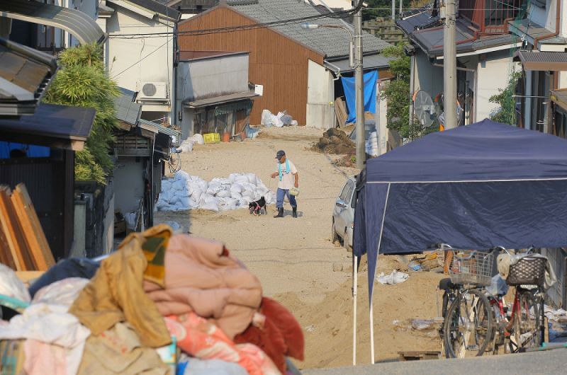 In Photos: Search for missing, cleanup work continues in disaster hit ...