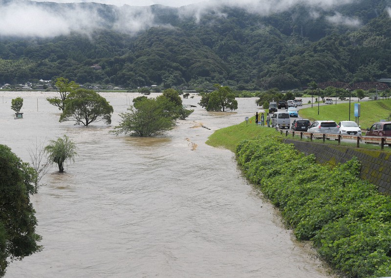 In Photos: Kuma River overflows as record rainfall strikes southwest ...