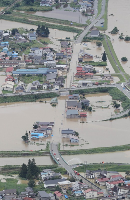 In Photos: Overflowing river in northern Japan floods communities - The ...