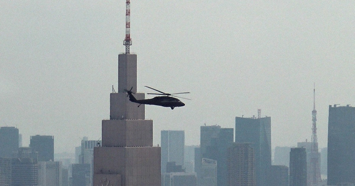 US military helicopters flying at low altitudes over downtown Tokyo ...