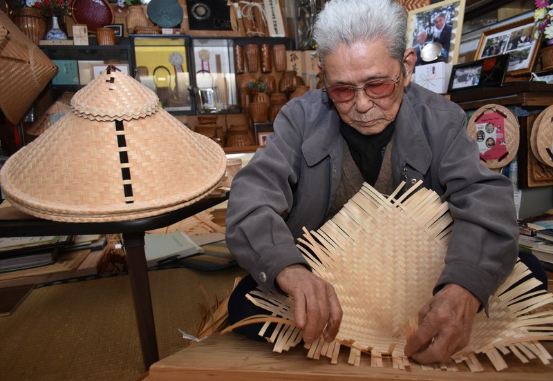 Centenarian conical woven hat craftsman keeps up millennium-old ...