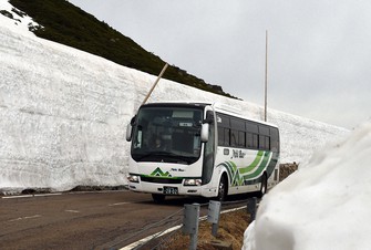 Scenic central Japan road sandwiched between 5-meter-high walls of snow ...