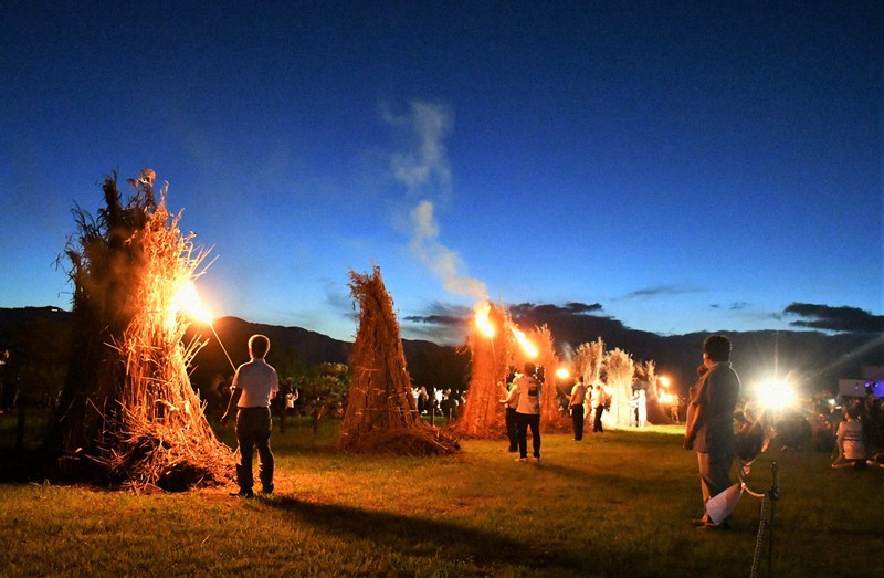 In Photos: Giant 'torches,' fireworks light up night sky on shore of ...