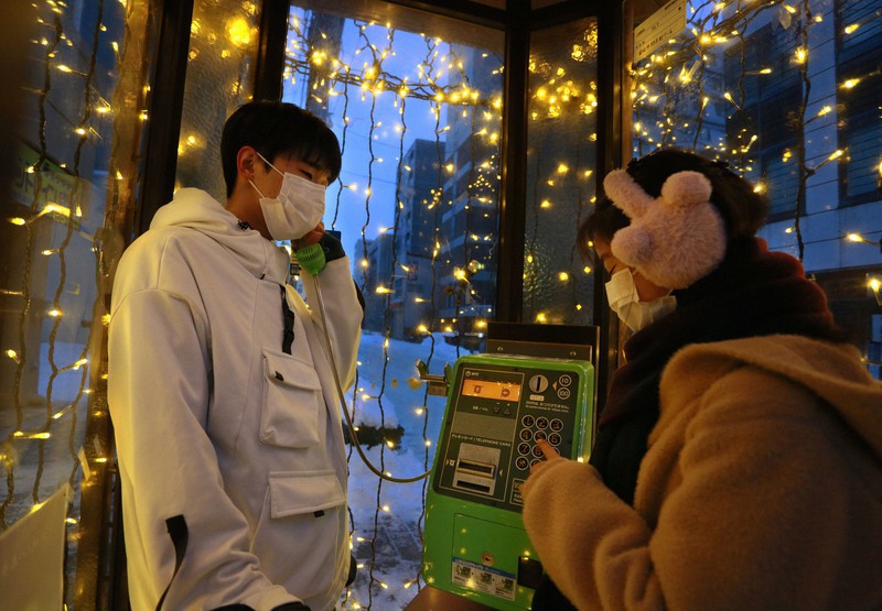 In Photos: Illuminated phone booth adds warmth to street in northeast ...