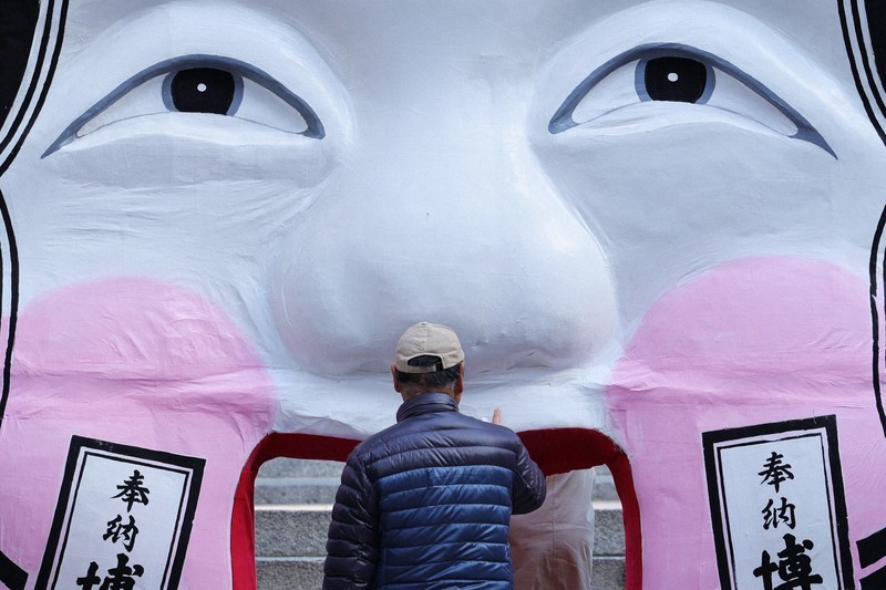 In Photos: Giant 'Otafuku' masks swallow visitors seeking good fortune ...