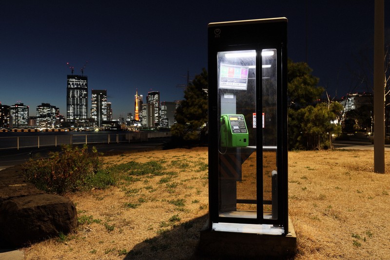 Tokyo Nightscapes: Pay phone at bayside park quietly waits for users in ...