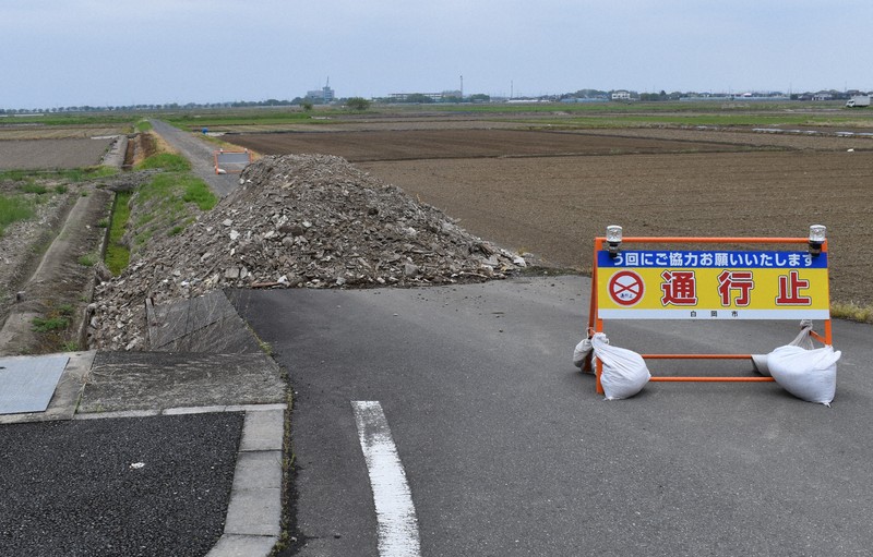 Large piles of likely industrial waste block 2 roads in east Japan city ...
