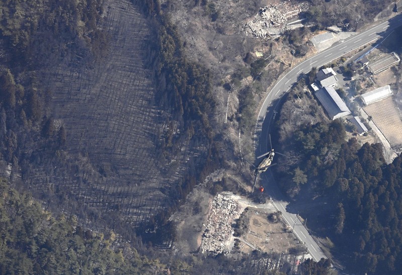 Tired residents seek relief after Japan wildfires hit city damaged by ...
