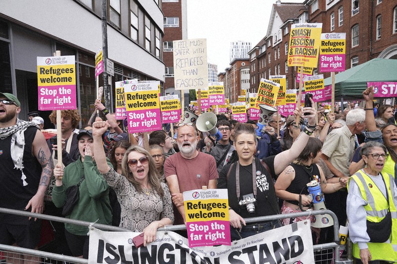 Rival anti-migrant and anti-racism protests face off outside a hotel ...